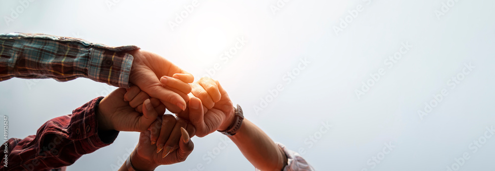Low angle view of team business workers standing bumping fists, Unity ...