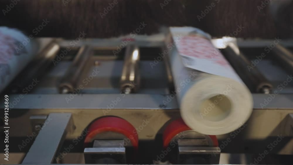 Roll of wallpaper. Conveyor line at wallpaper factory. A roll of ...