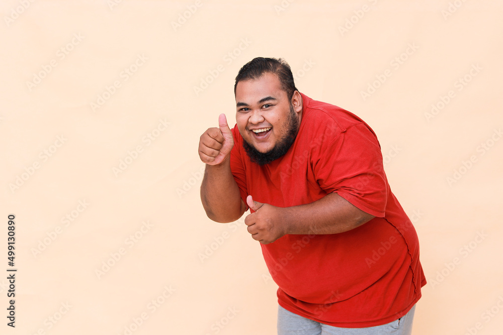 Young asian fat man wearing red T Shirt isolated background smiling ...