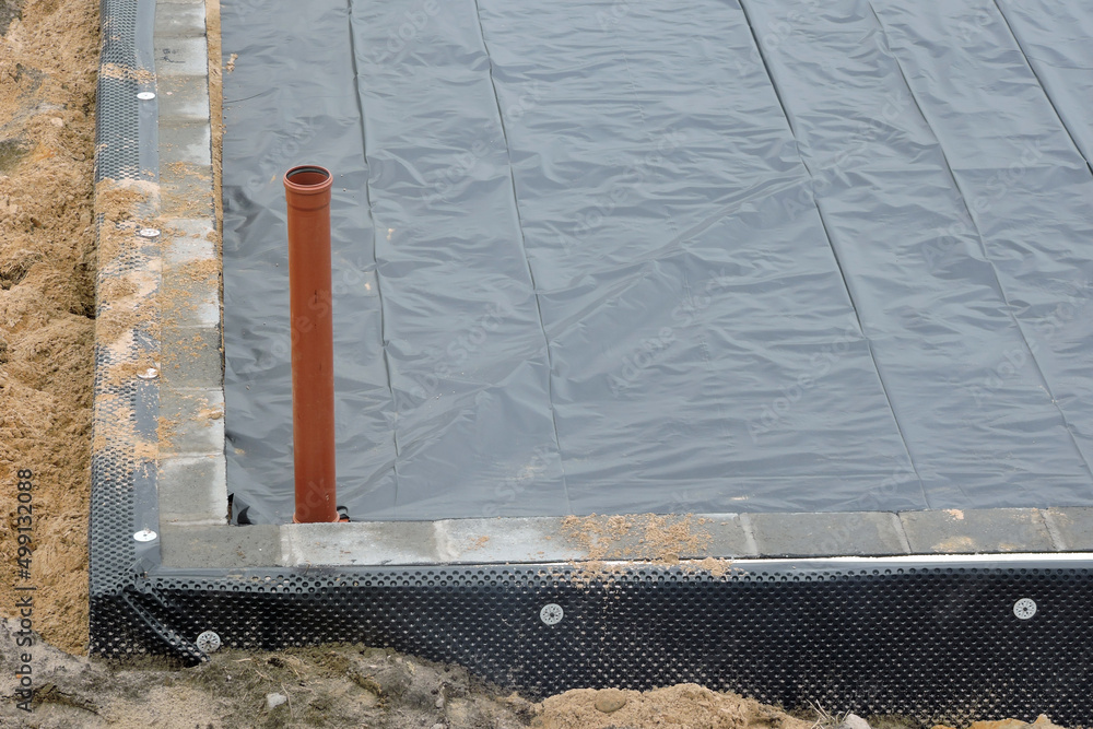 Damp proof membrane laid under a slab foundation, insulated foundation ...