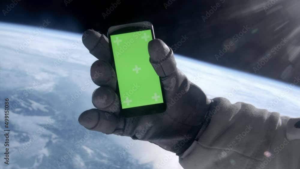 View through the helmet, astronaut using his mobile phone during the ...
