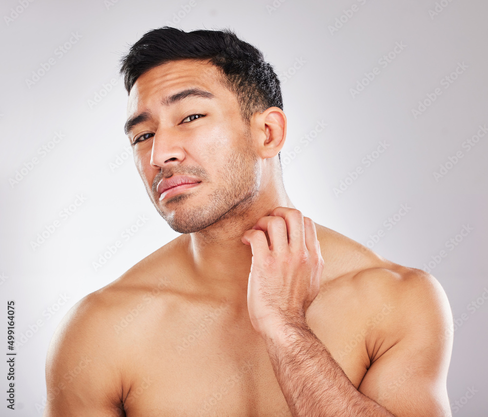 No man escapes ageing. Portrait of a young man checking his skin and ...