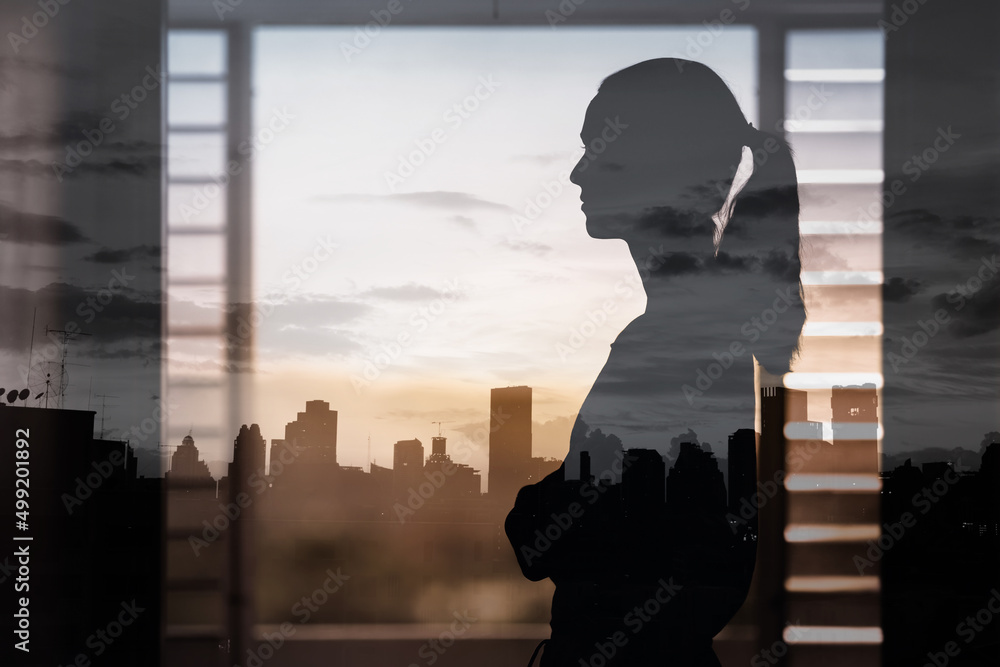 Young confident woman looking out her window at the city Stock Photo ...