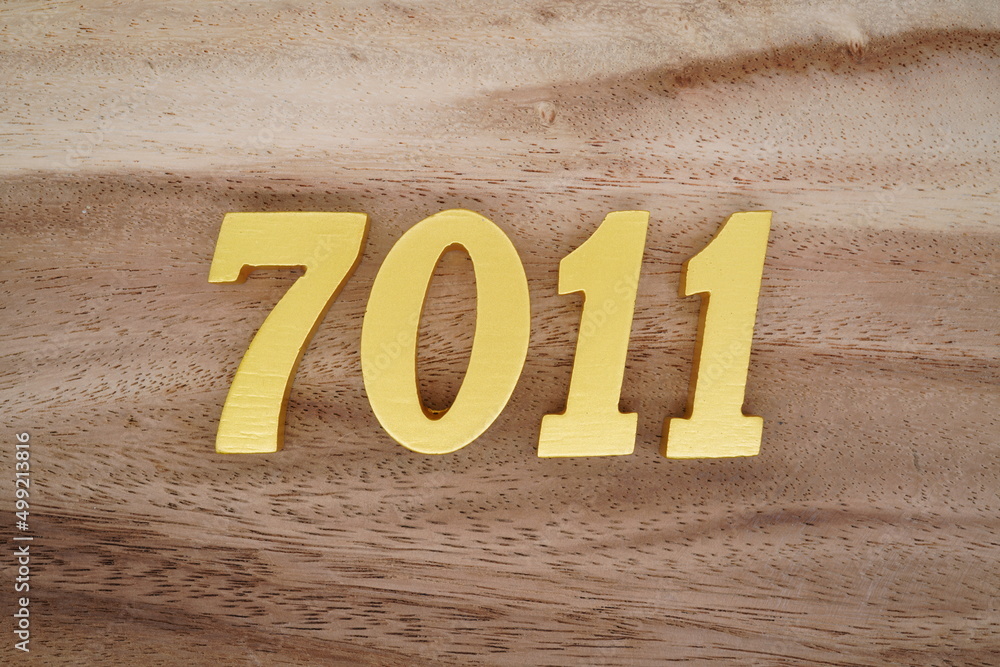 Foto de Golden Arabic numerals on a real brown and white wooden floor ...