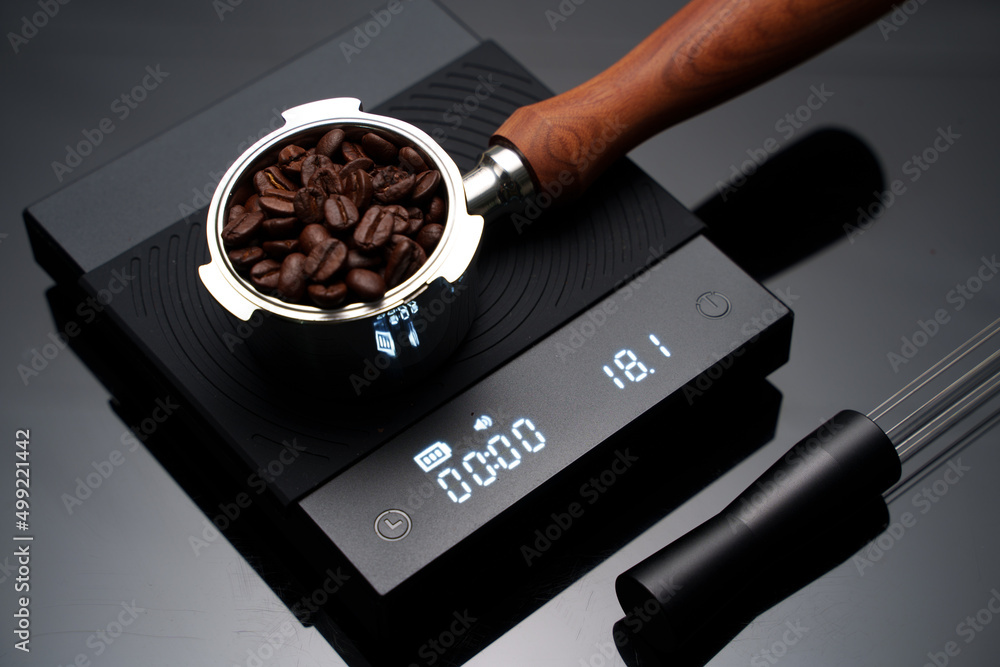 Coffee bean inside the espresso bottomless portafilter on top of a ...