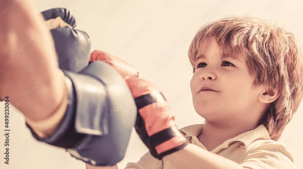 Father is training his son boxing. Little boy doing boxings exercise ...