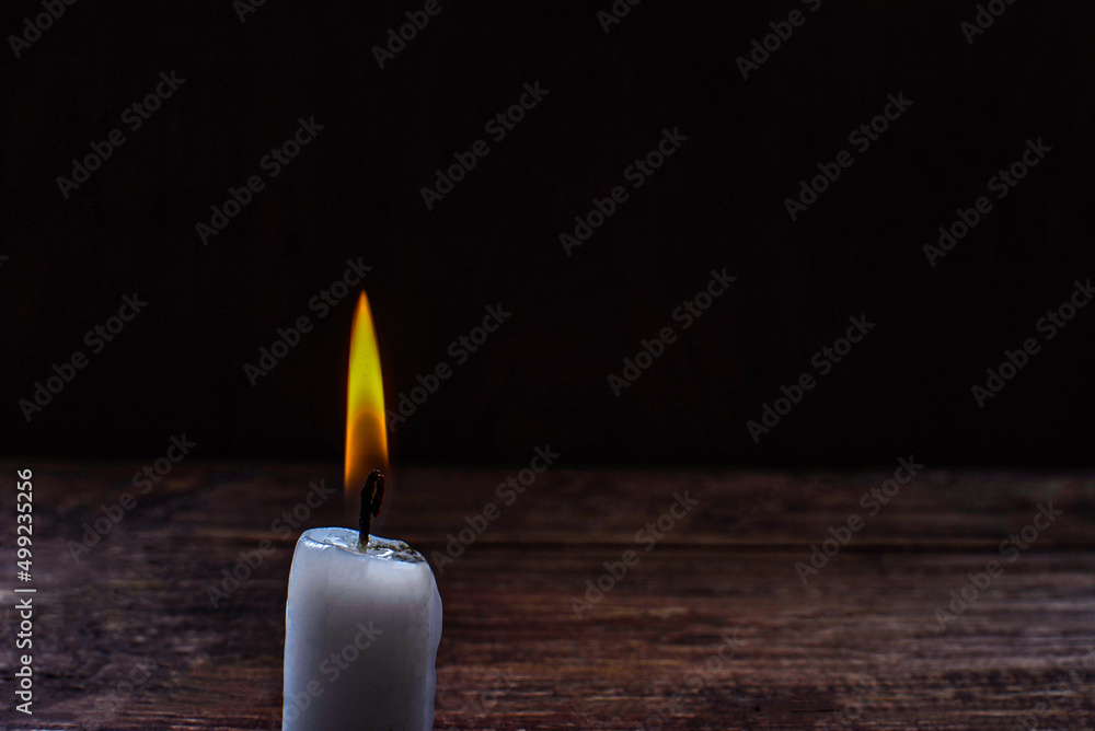 Candle light in darkness as light for life. Stock Photo | Adobe Stock