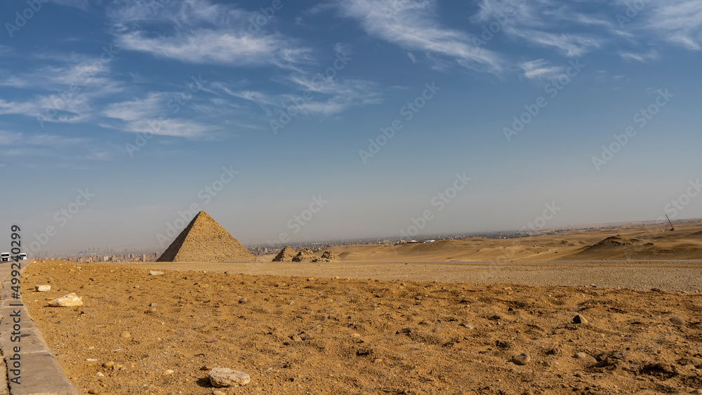 The great Pyramid of Menkaure and three small pyramids of queens stand ...