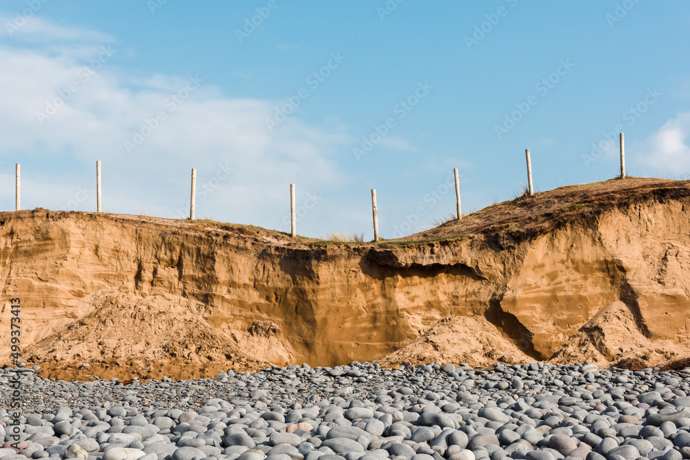 Eroded sand on uk beach showing erosion caused by rising sea levels on ...
