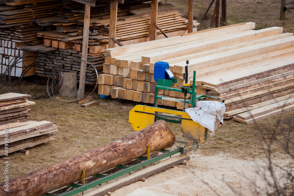 Sawmill. Process of machining logs in equipment sawmill. Machine saw ...