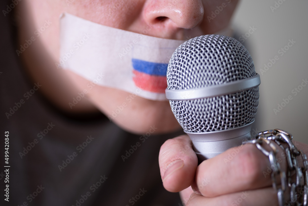 A duct-taped mouth with a Russian flag, trying to speak into a ...
