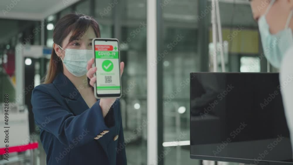 Asian Businesswoman wearing face mask showing vaccine information on ...