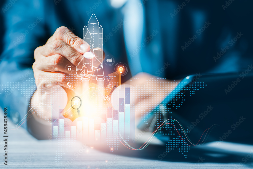 Businessman is pointing the glowing rocket space ship with marketing ...