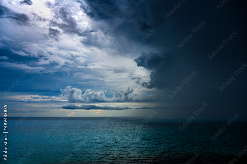 Dark thunderstorm clouds with rain over ocean Stock Photo | Adobe Stock
