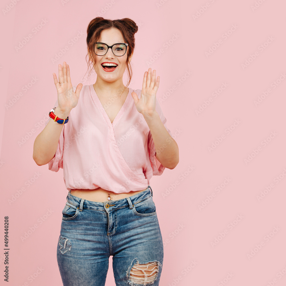 Overly positive eccentric lady throwing hands up in joy. Over pink ...