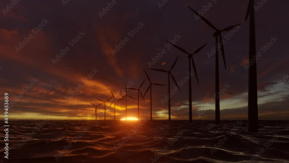 Wind turbines on the ocean at sunset. Beautiful orange sun and cloudy ...