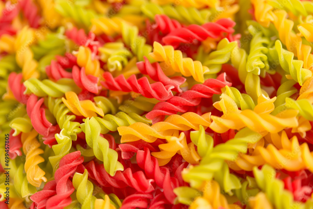Close-up background of Fusille and Rotini in a glass bowl on white ...