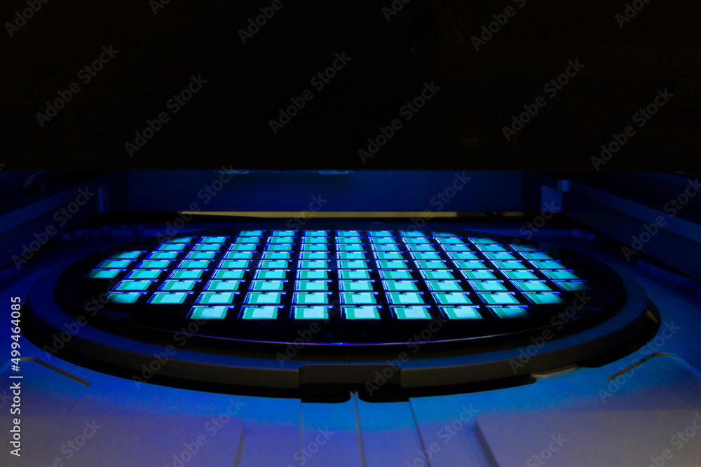 Silicon wafer with chips in UV lighting. Neon. Ultraviolet Lithography ...