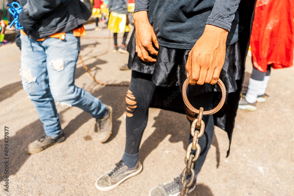 Close-up on the hand of a young traditionalist who is holding a chain ...