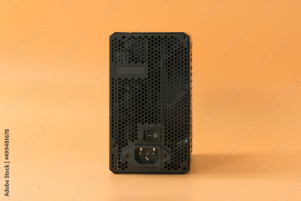 Back view of socket, button and grates of a computer power supply unit ...