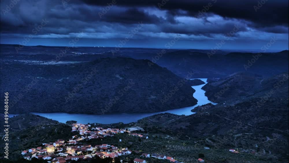 Time lapse of dark stormy clouds moving in evening over Douro river and ...