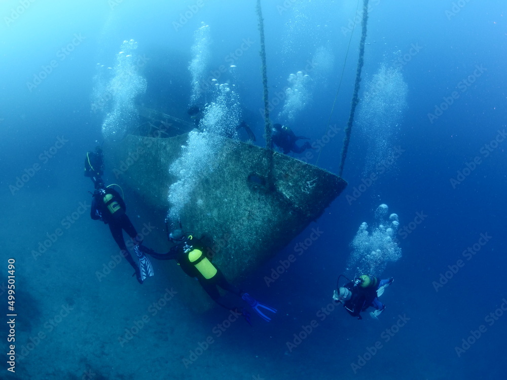 ship wreck underwater deep sea bottom metal on ocean floor scuba divers ...