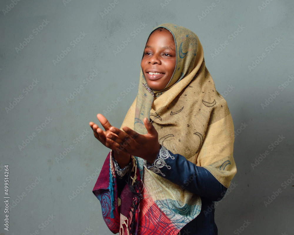 An African Nigerian female muslim lady with Hijab scarf, engaging the ...