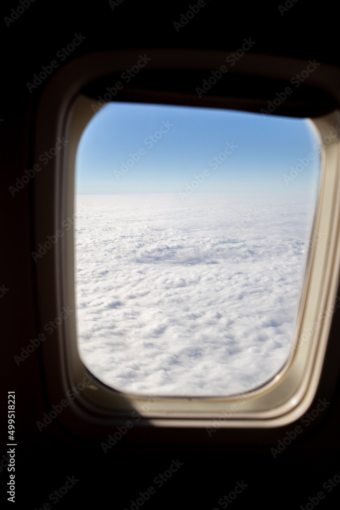 Airplane flight. Wing of an airplane flying above the clouds. View from ...
