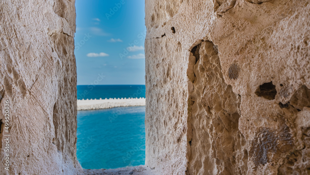 A narrow window opening in the walls of the ancient Citadel of Qaitbay ...
