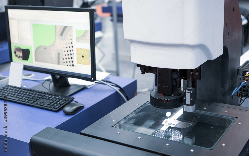 Vision measuring machine inspecting workpiece. Industrial manufacture ...