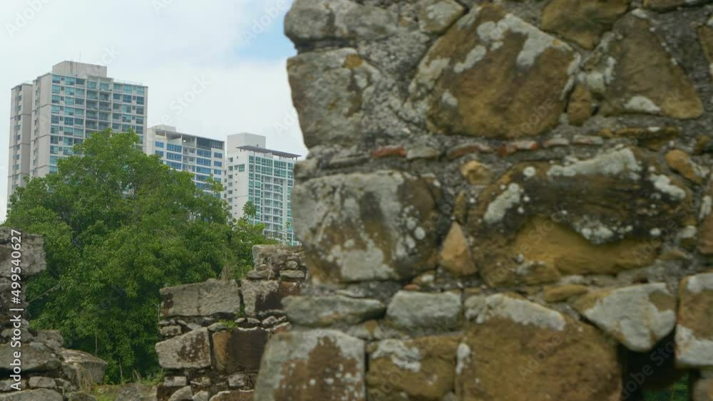 CLOSE UP: Modern high rise buildings overlook the ruins of Panama Viejo ...