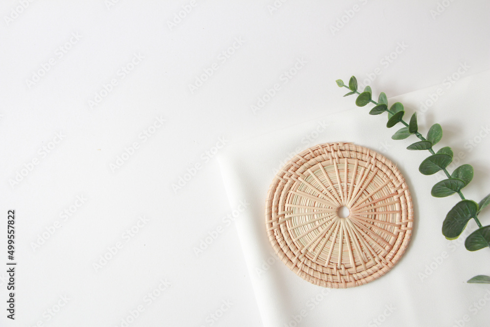 rattan coaster and white fabric background for cosmetic products. top ...