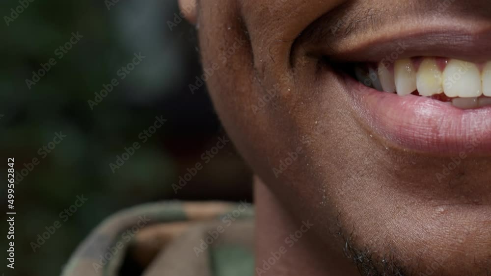 Macro shot of man showing half of face in front of camera, smiling with ...
