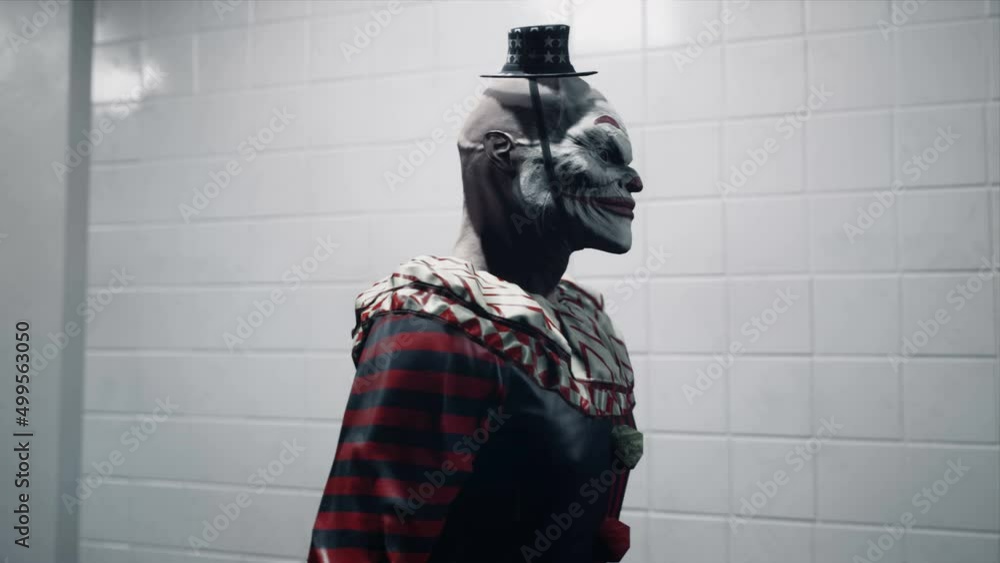 A nightmarish clown in a hospital deserted hallway prepares to commit a ...