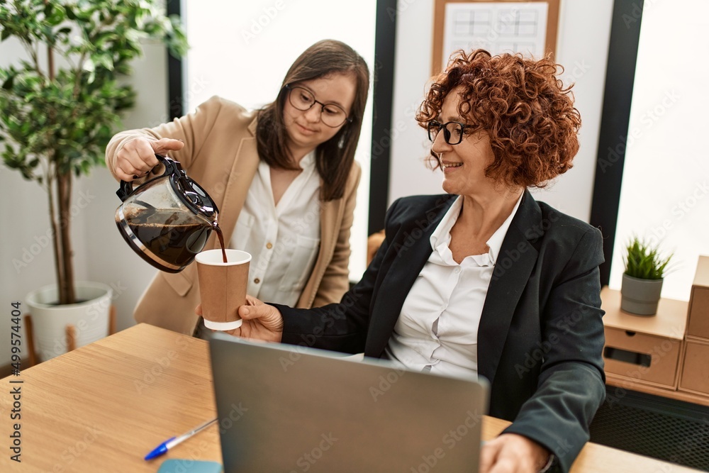 Group of two women working at the office. Mature woman and down ...