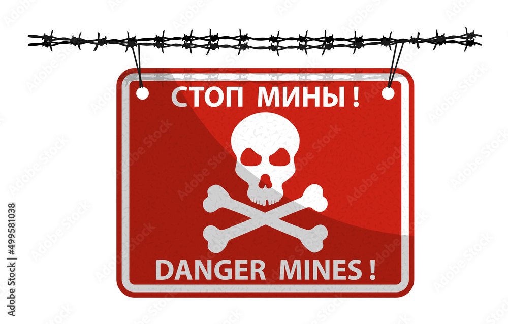 red sign plate with skull and crossbones hangs on barbed wire. Hazard ...