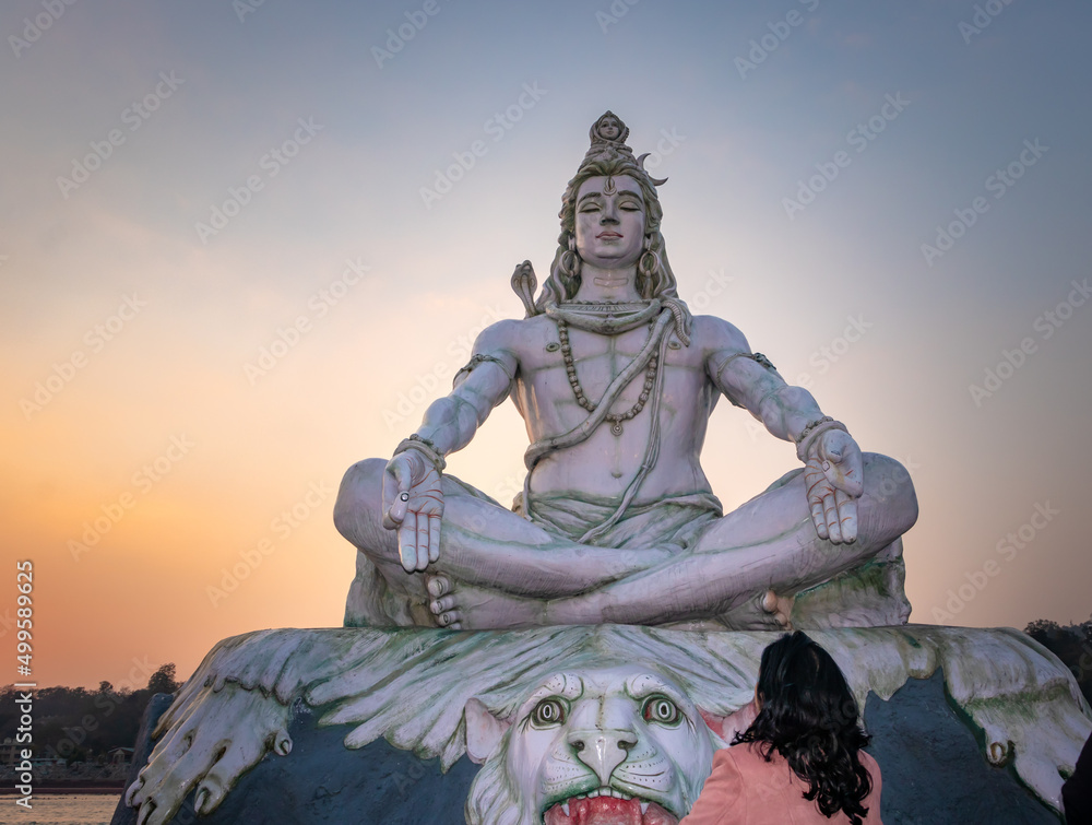 hindu god lord shiva statue in meditation posture with dramatic sky at ...