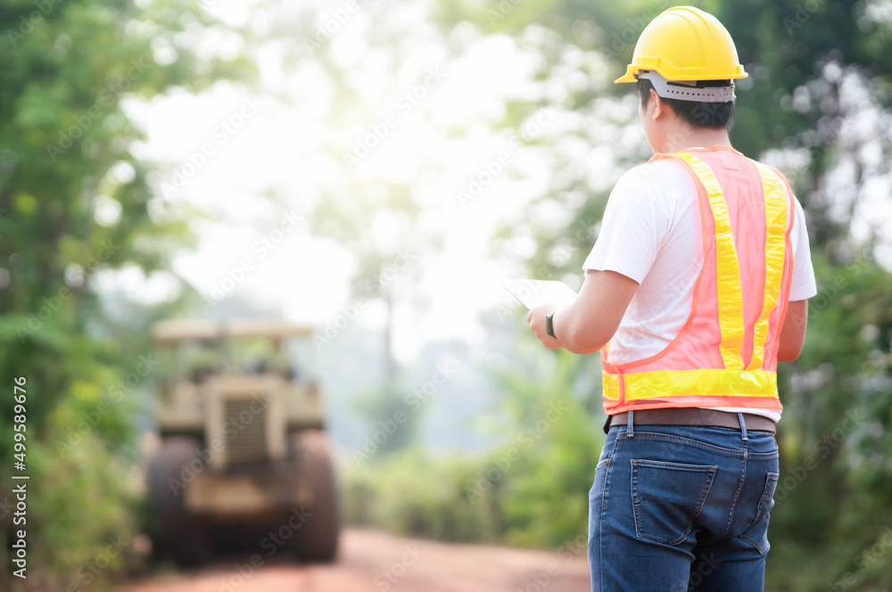 Civil engineers in reflective vests, helmets, check plans and plans in ...