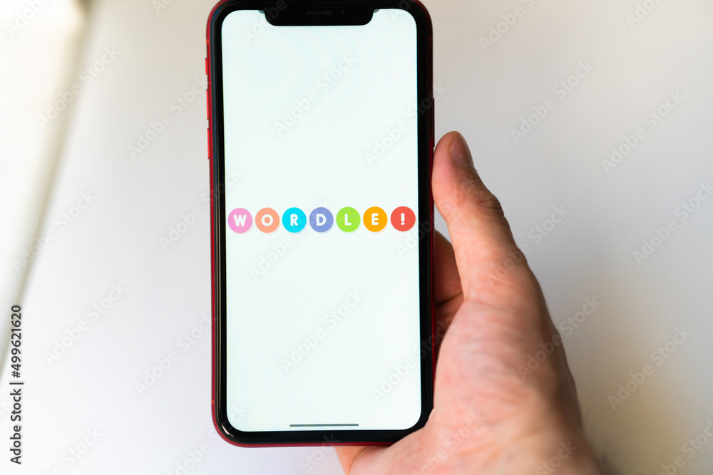 Man plays Wordle on its official app on him iPhone. The word game ...