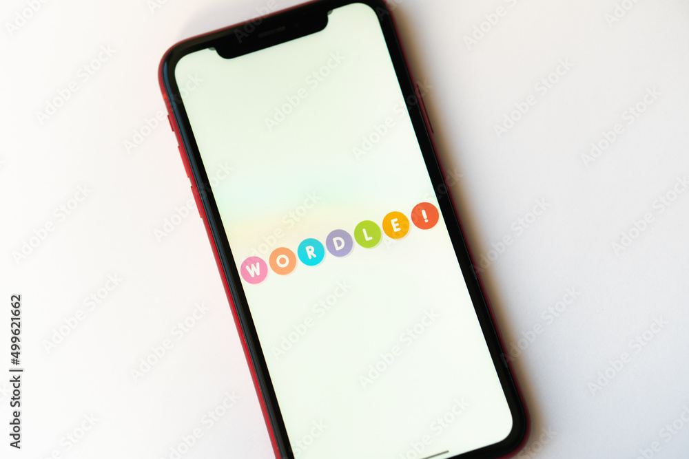 Man plays Wordle on its official app on him iPhone. The word game ...