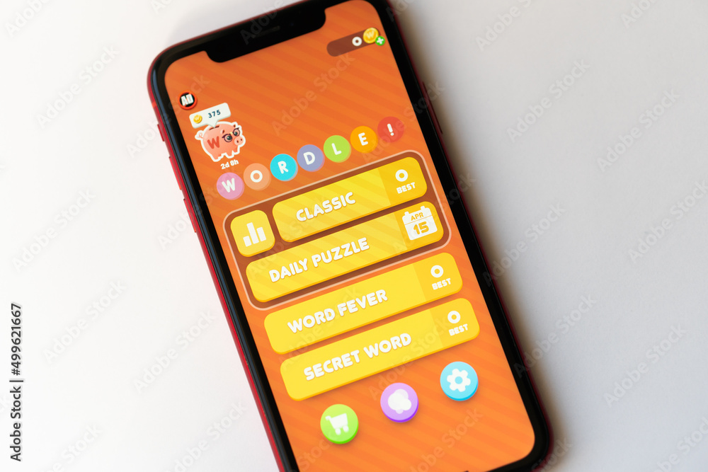 Man plays Wordle on its official app on him iPhone. The word game ...