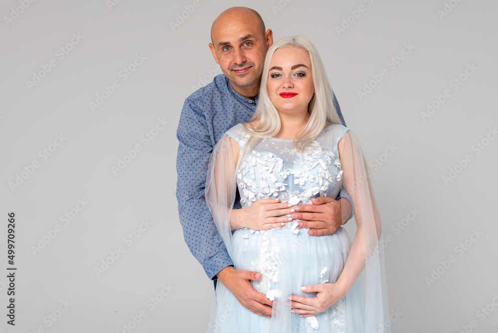 Handsome, emotional man and his beautiful pregnant woman hugging and ...