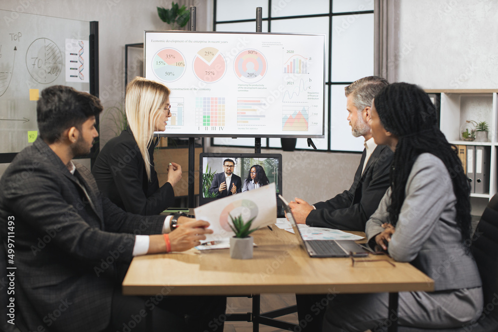 Focused multiracial business people in conference room, looking at a ...