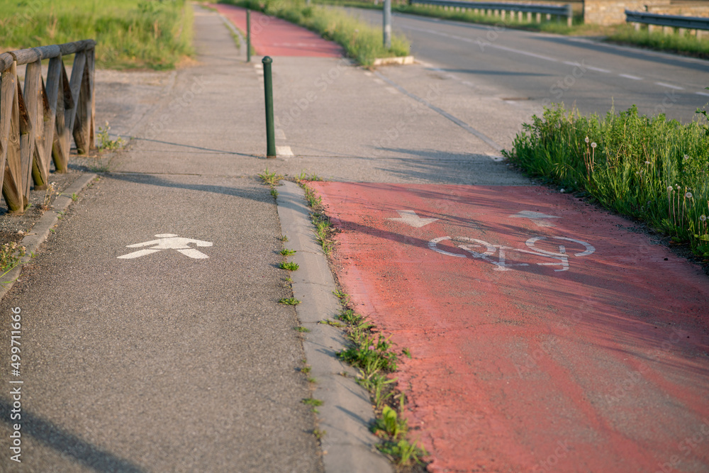 cycle path, with road signs on the pedestrian side and on the bike and ...