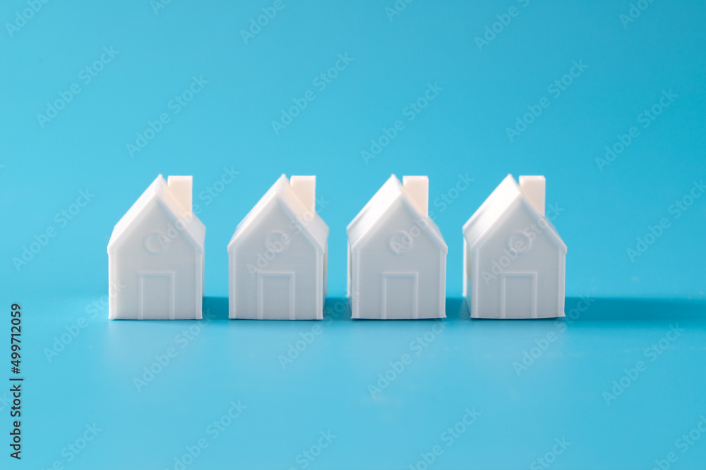 Miniature 3D printed model house on blue background for home or real ...