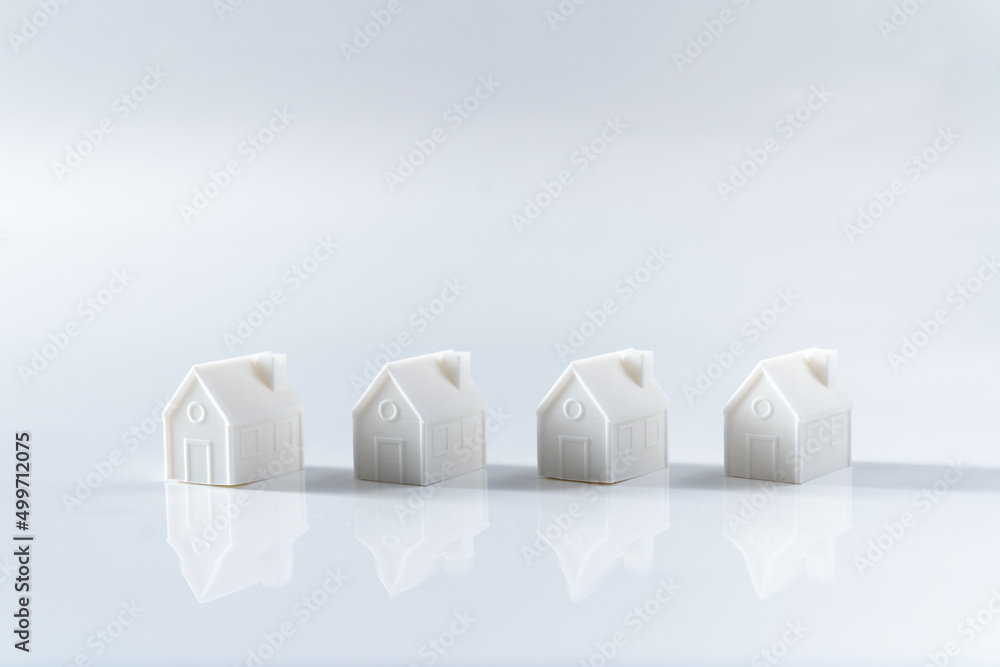 Miniature 3D printed model house on white background for home or real ...
