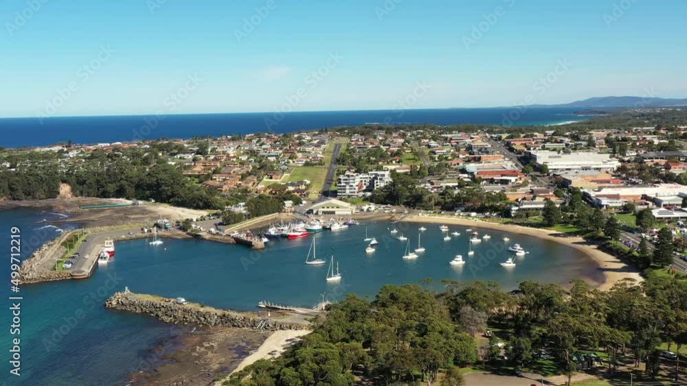 Aerial flying down to Ulladulla town harbour on South coast of ...