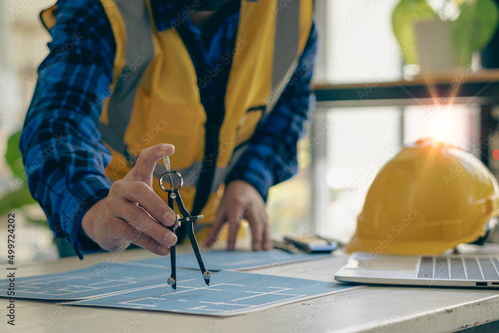 Professional architect working on blueprints and construction plans ...
