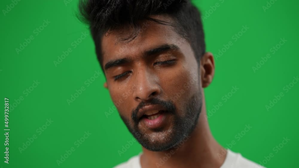 Close-up exhausted Middle Eastern perspiring sportsman looking at ...