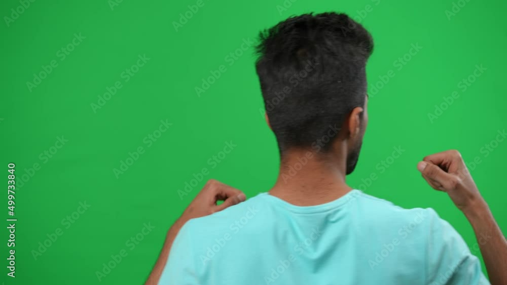 Vidéo Stock Back view motivated Middle Eastern man gesturing cheering ...